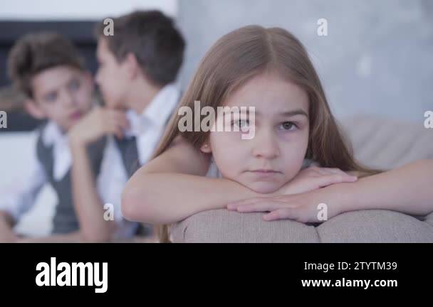 Close-up portrait of sad beautiful little Caucasian girl with brown ...