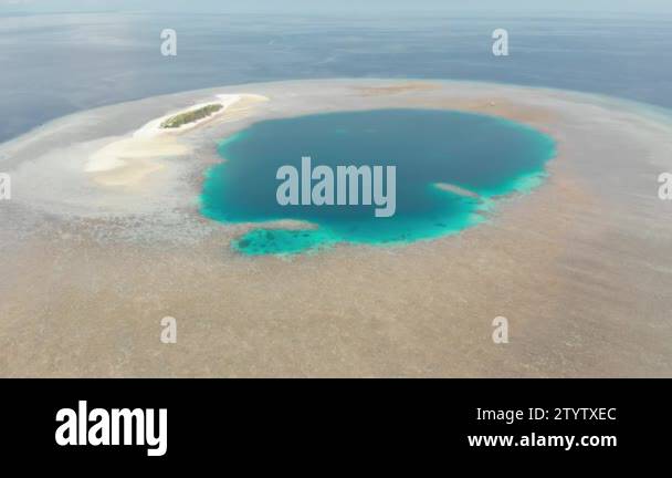 Aerial: Flying over idyllic atoll, travel destination Wakatobi National ...