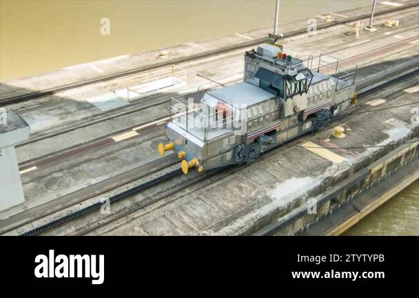 Panama Canal Locomotive Train on Tracks Close-up Guiding a Ship Through ...