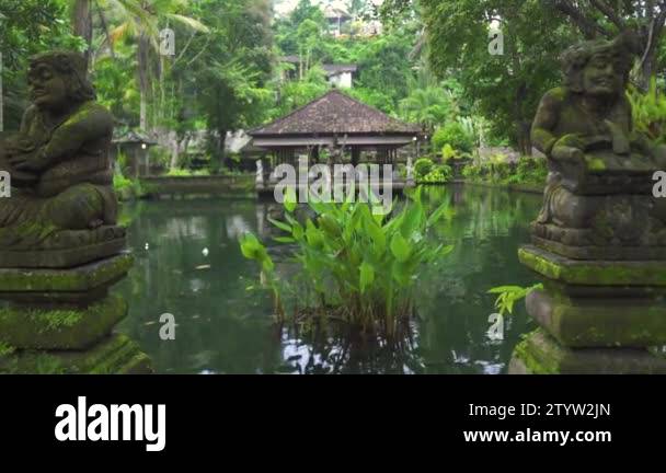Indonesia god statue in water pond at Bali temple, Indonesia ...