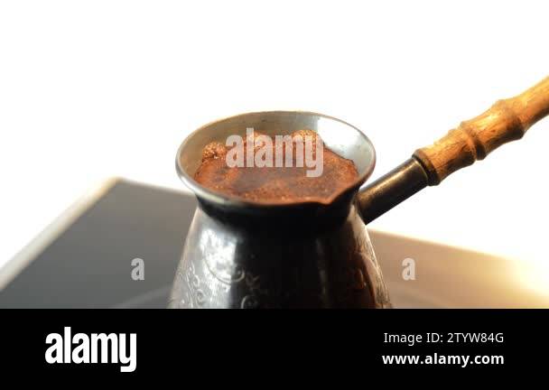 Preparation of ground coffee in cezve.Cooking turkish coffee in cezve ...