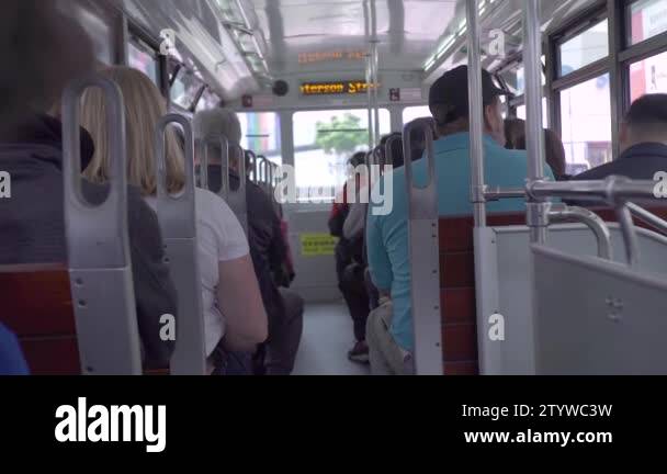 Passengers on seat riding tram on street modern city. Back view people ...