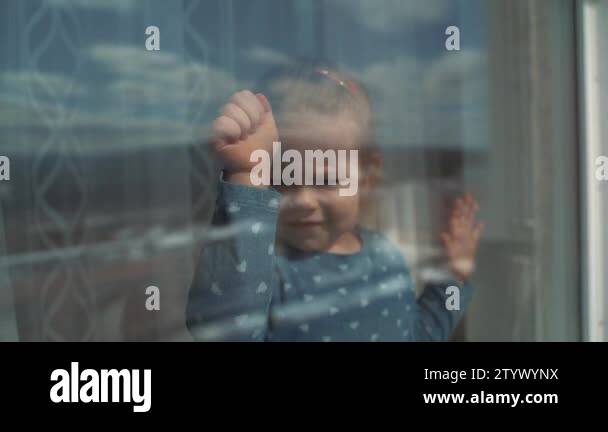 The child is at home in isolation outside the window, crying and wants ...