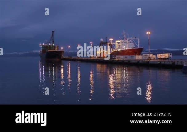 Container Ship and Fishing Boat moored by the Jetty in Ushuaia, the ...