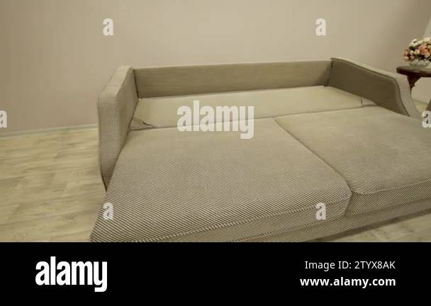 Stylish beuge sofa made of eco-friendly materials is laid out in a ...
