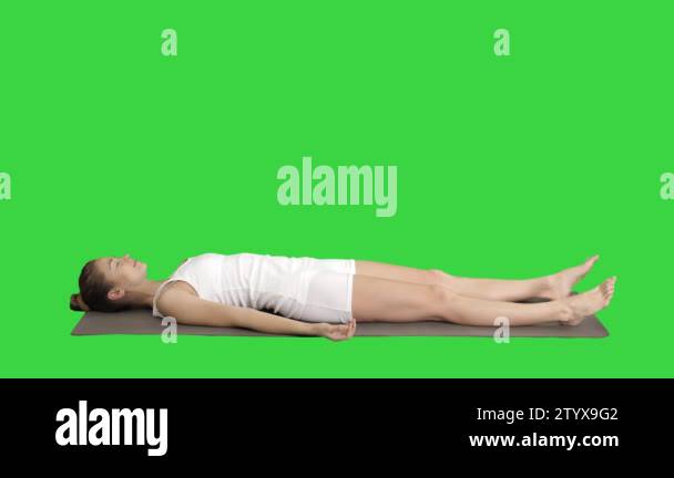 Yoga meditation laying on a mat with closed eyes on a Green Screen ...