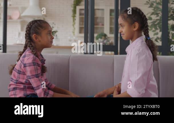 Carefree african sisters playing staring contest Stock Video Footage ...