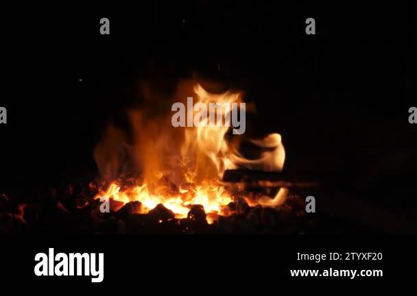 Blacksmith forge with flaming fire looking like a monster`s maw in an ...