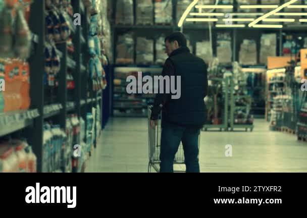 At the Supermarket: Man Pushing Shopping Cart Through Fresh Produce ...