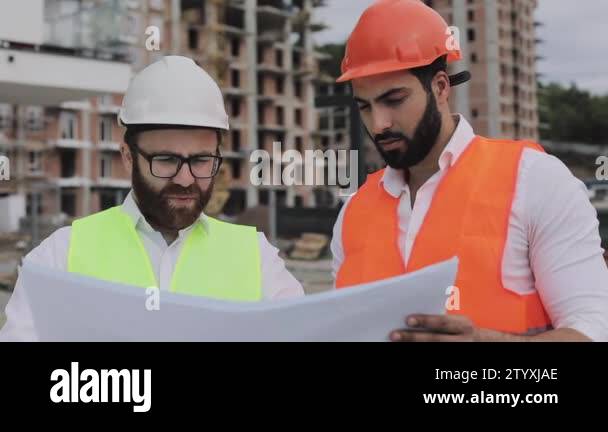 Architect expert engineers talking and analyze design plan standing ...