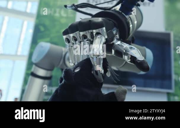 New technologies among us. The hand of the robot takes a soft toy in ...