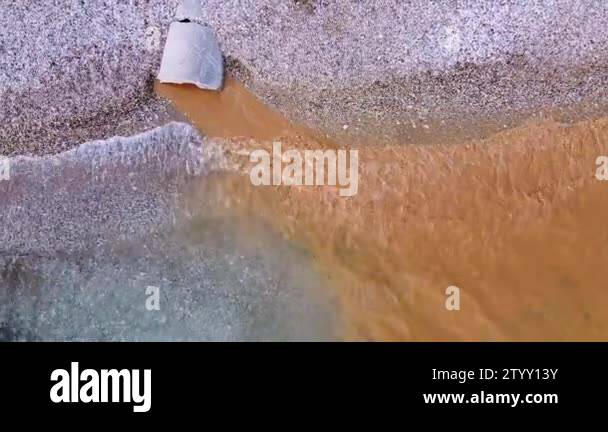 Chemical waste from industrial plant or construction mud with red clay ...