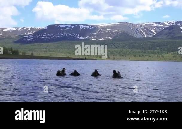scuba diving in a mountain lake, practicing techniques for emergency ...