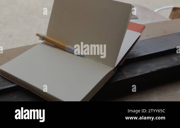 Wind turns the pages of a blank notepad lying on the window sill Stock ...