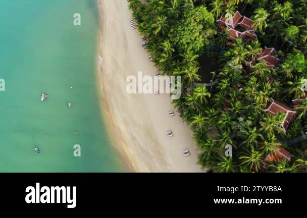 Blue lagoon and sandy beach with palms. Aerial view of blue lagoon and ...