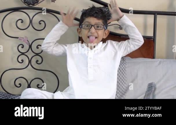 Funny Mocking little boy child tongue out making faces and hand gesture ...