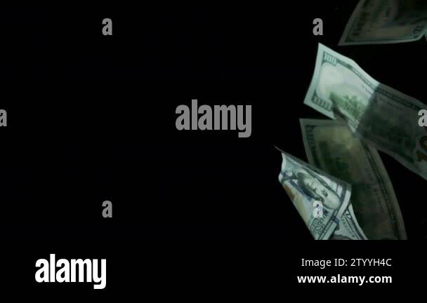 Falling flying american canadian dollar banknotes on a black background ...
