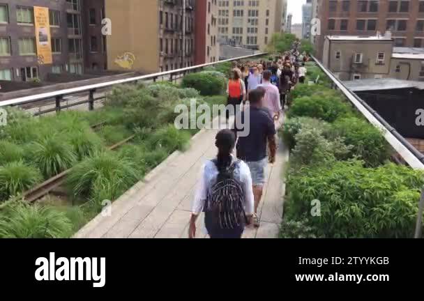 NEW YORK CITY, MAY 2015. People relaxing on the High Line Park. The High Line is a park built on ...