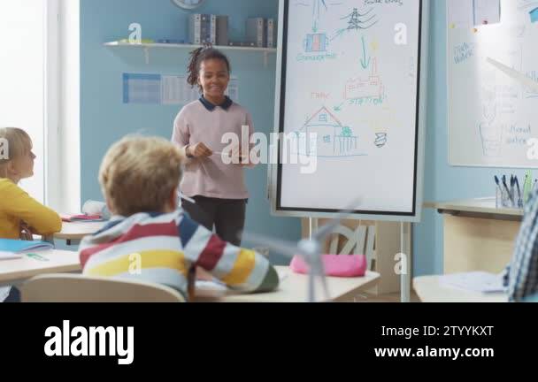 Elementary School Science Class: Cute Girl Uses Interactive Digital ...