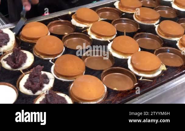 Making delicious obanyaki or imagawayaki by drop the young bread into a ...