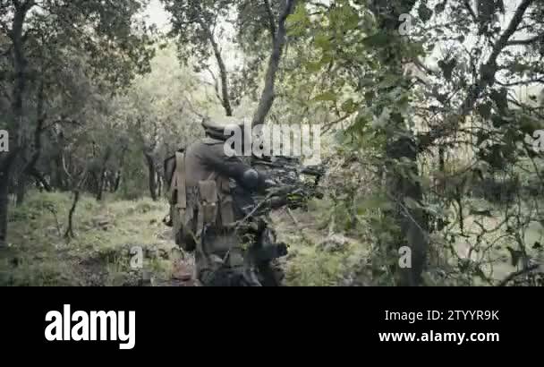 Squad of fully armed commando soldiers during combat in a forest ...