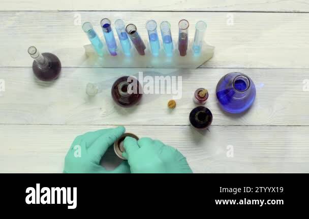 scientist dropping the reagent into test tube for reaction testing in ...