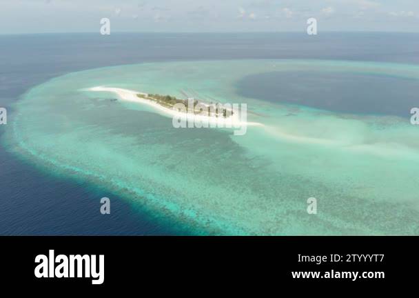 Aerial: Flying over idyllic atoll, travel destination Wakatobi National ...