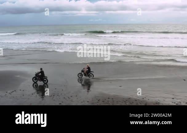 Two handsome hipster men riding modern custom motorcycle cafe racer on ...