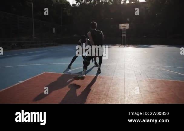 Two Young Active Mixed Race Guys Playing Basketball, Bouncing ball, One ...