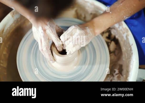 Traditional pottery making, man teacher shows the basics of pottery in ...