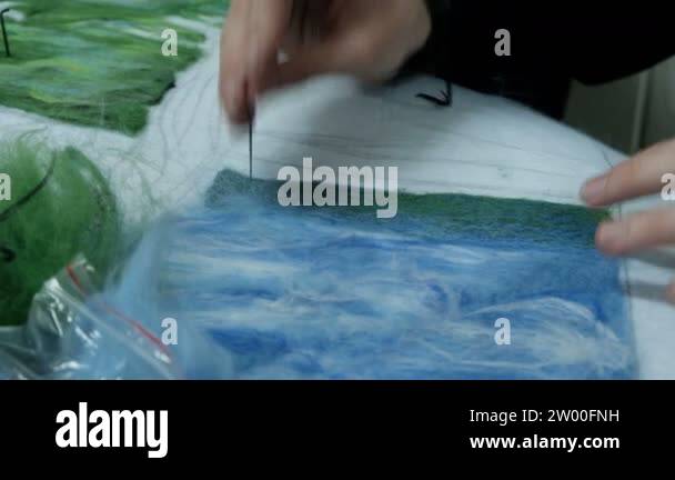 Children work with dry felt. Needle for making paintings from wool ...