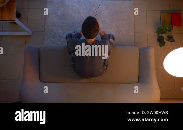 Closeup top shoot of young male playing video games on TV using game ...