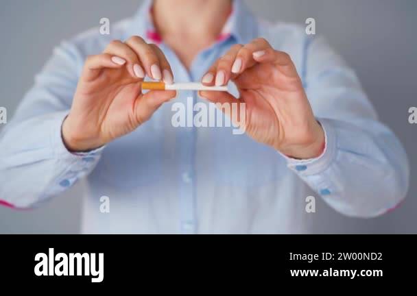 Quit smoking concept, woman breaks a cigarette Stock Video Footage - Alamy