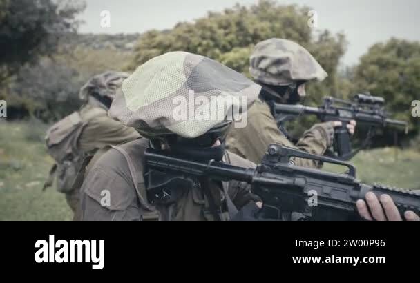 Squad of fully armed commando soldiers during combat in a forest ...