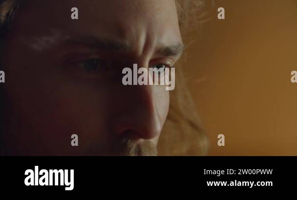 Close up view of young good looking mans face creating art object ...