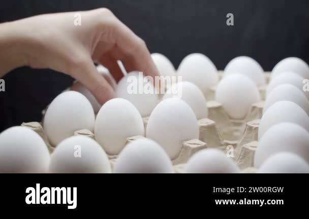 Eggs are stacked in a tray. Crates of fresh eggs at a poultry farm ...