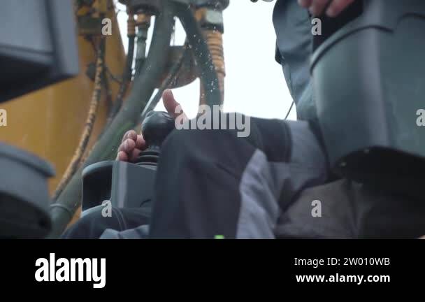 Engineer operator crane in action. Clip. Man in cabin controls the ...