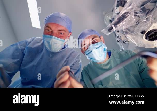 Surgeons During Operation. Patient point view of surgeons team work ...