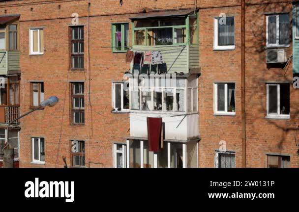 Windows and balconies of the old brick apartment building of the USSR ...