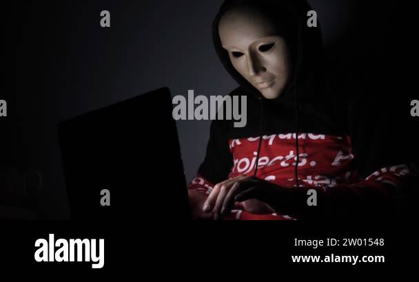 Male hacker hidden face with the mask accessing to personal information ...