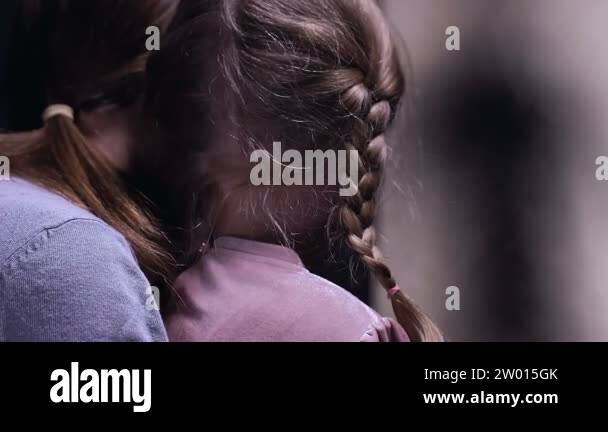 Two sisters in horror covering faces with hands, scared of evil father ...