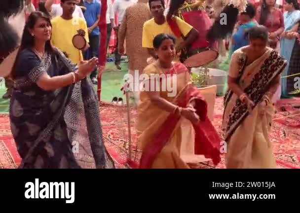 Kolkata, India, 2020. Shot of ladies dancing with Dhunachi emitting ...