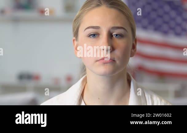 Sad single mother looking camera, little girl playing behind ...