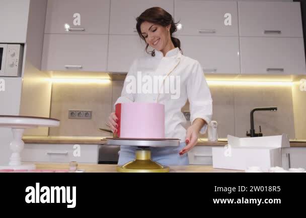 Female baker is making a birthday cake in a modern kitchen Stock Video ...