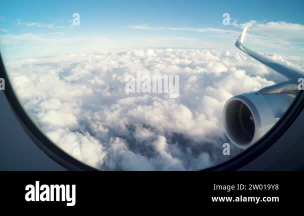 Airplane flying slightly above the clouds. Inside view through the ...