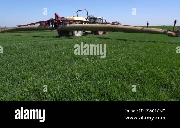 Sprayer Spraying A Wheat Field in Springtime - Slow Motion. Large ...