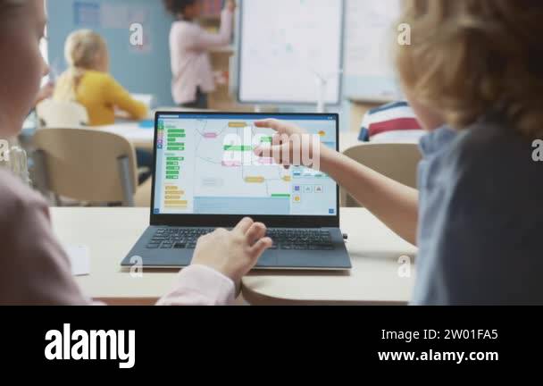 Elementary School Science Class: Over the Shoulder Little Boy and Girl ...