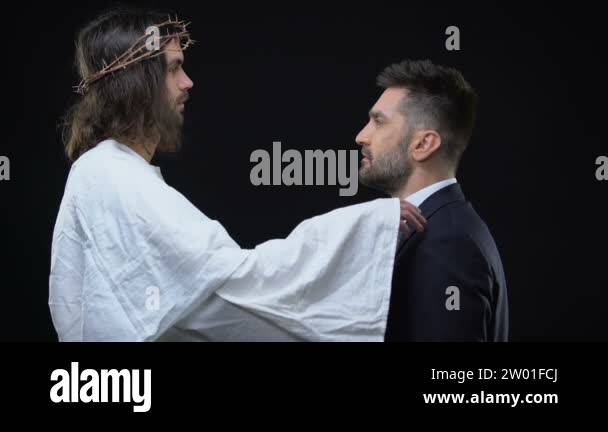 Forgiving Christ putting hand on businessman shoulder, looking each ...