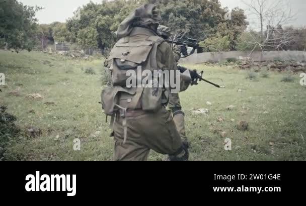 Squad of fully armed commando soldiers during combat in a forest ...