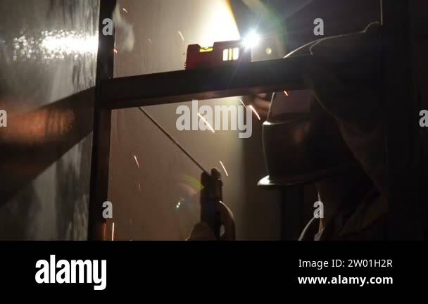 Welder Worker Performs Jump Welding. Worker Welder Performs Arc-Welding ...